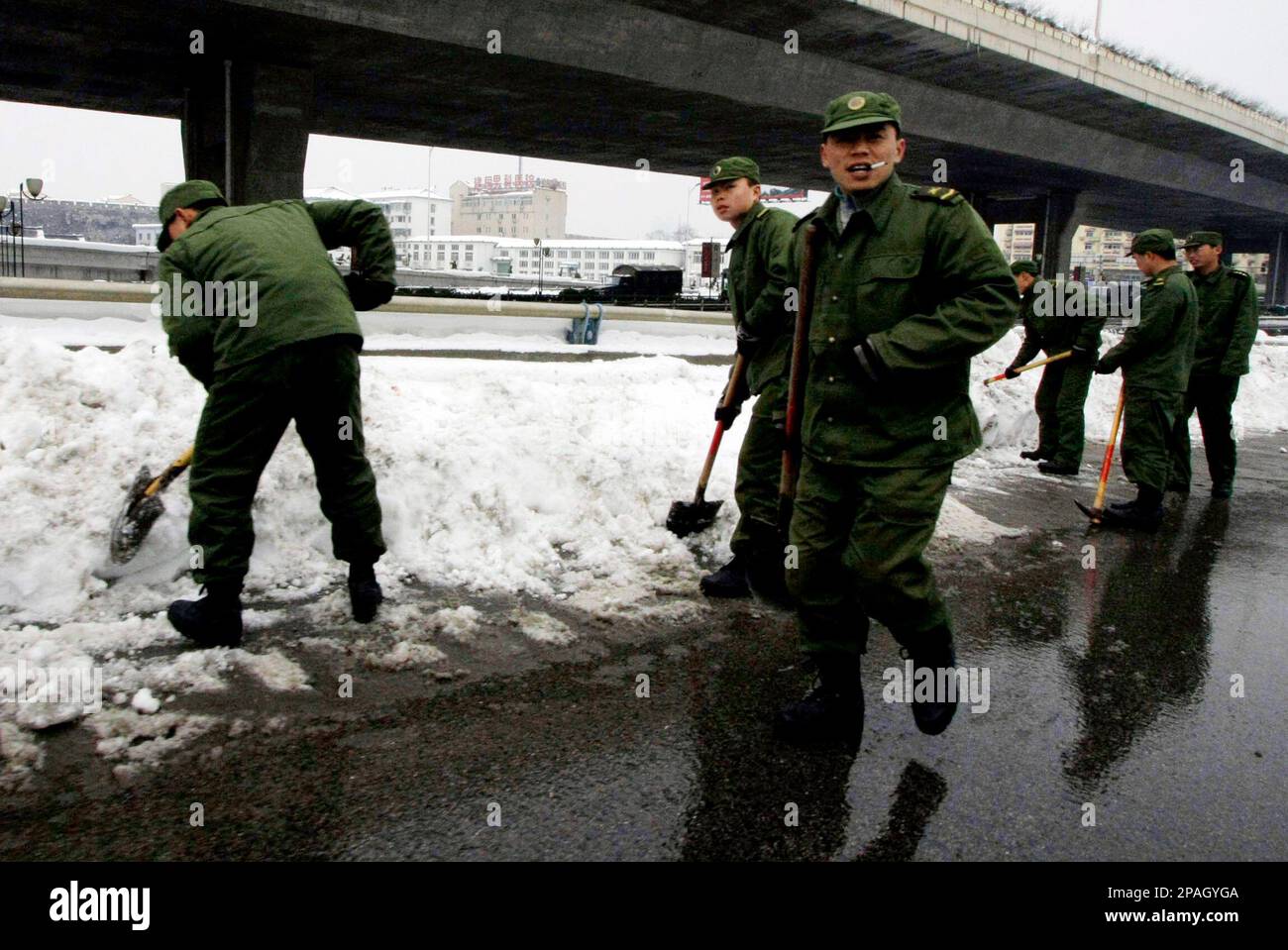 Chinese soldiers clean up icy snow from a freeway Saturday Feb. 2, 2008 ...