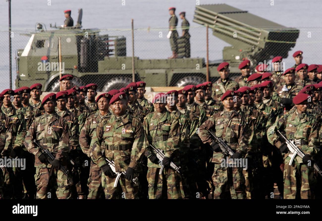 Soldiers of Sri Lanka's army march as a multi barrel rocket launcher is ...