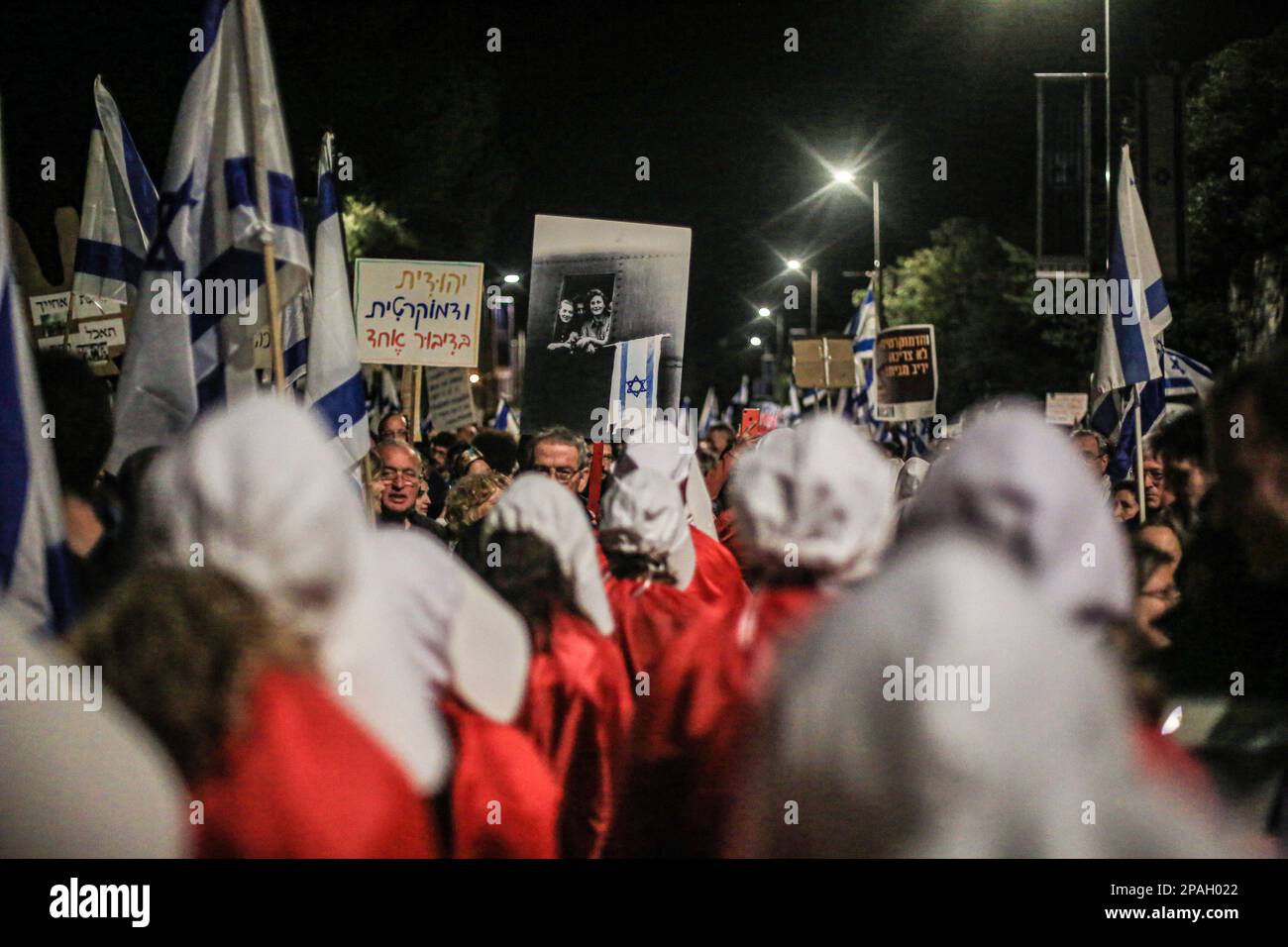 Jerusalem, Israel. 11th Mar, 2023. Female protesters wear red robes and ...