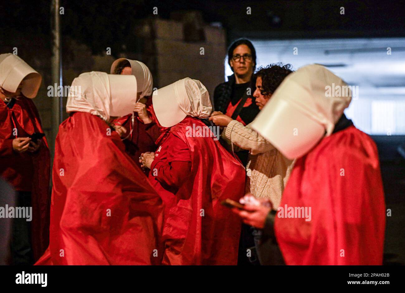 Jerusalem, Israel. 11th Mar, 2023. Female protesters wear red robes and ...