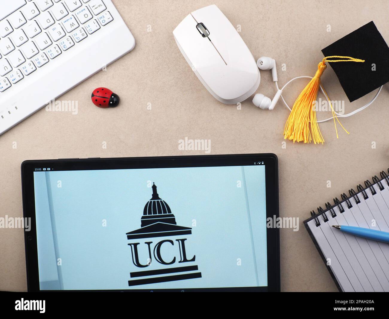 In this photo illustration, UCL logo seen displayed on a tablet Stock ...