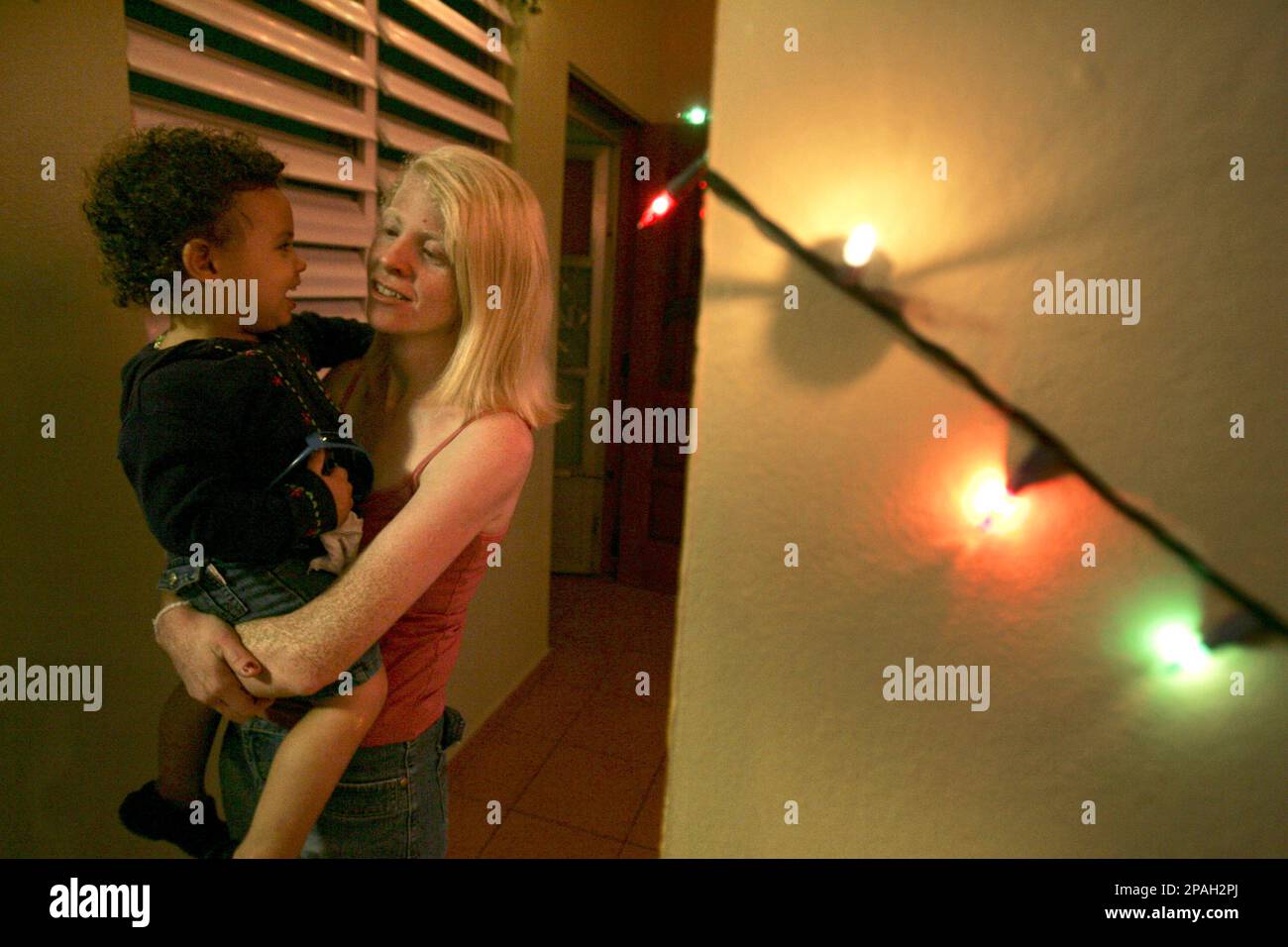 Puerto Rican Mayra Nieve, who suffers from albinism, holds her daughter ...