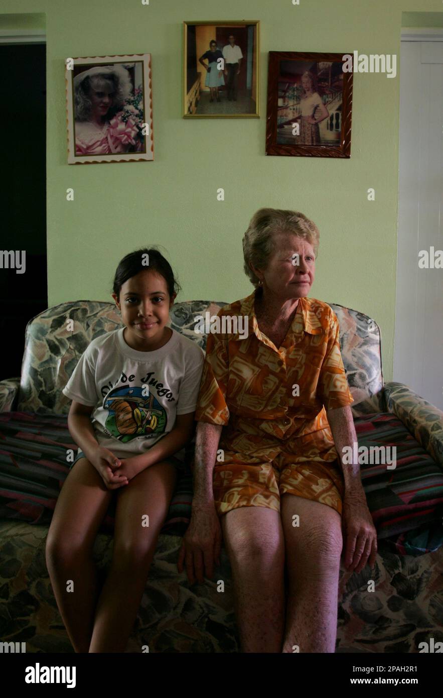 Puerto Rican Rita Nieve, right, who suffers Type 1 HPS albinism, sits ...