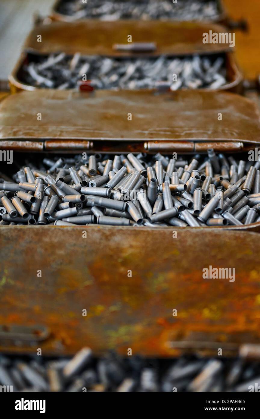 Metal containers full of bullet casings on table at plant Stock Photo ...