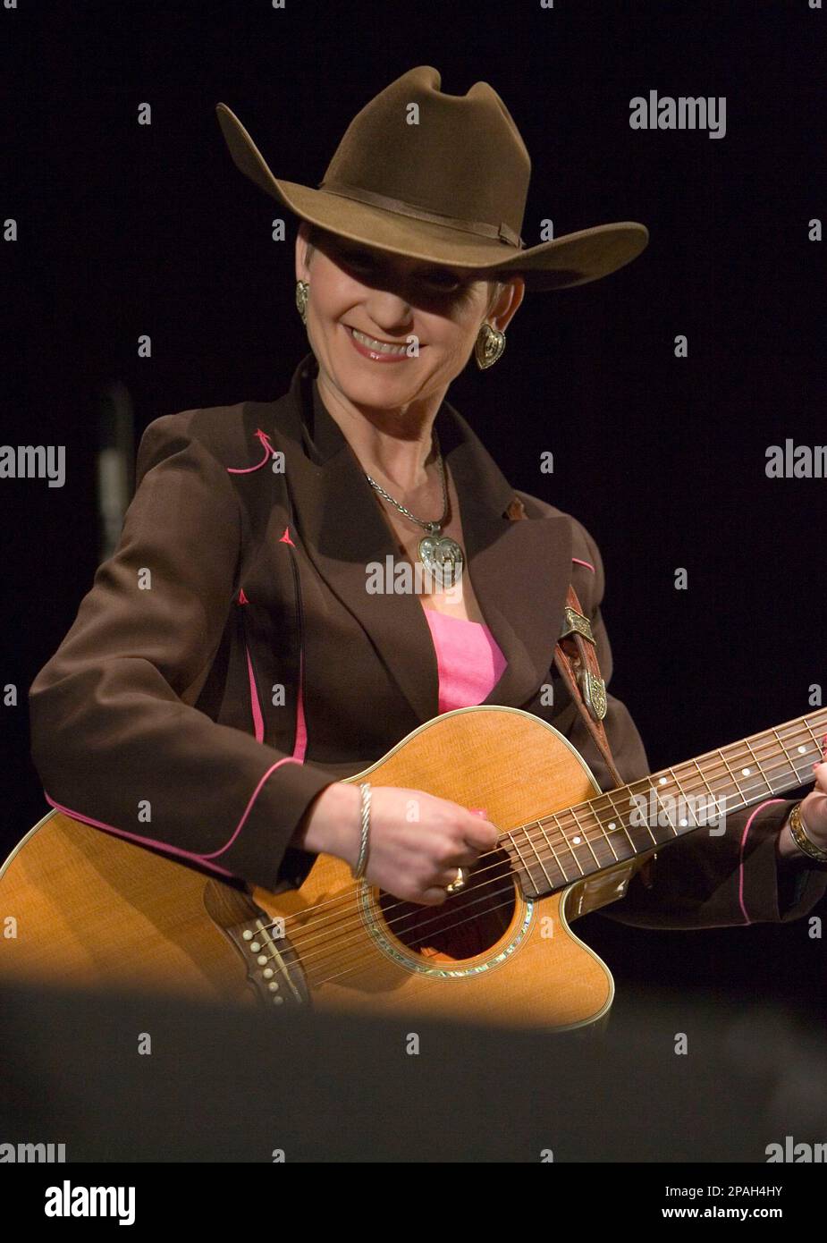 Joni Harms smiles as she plays her guitar with her band during the 2008 ...