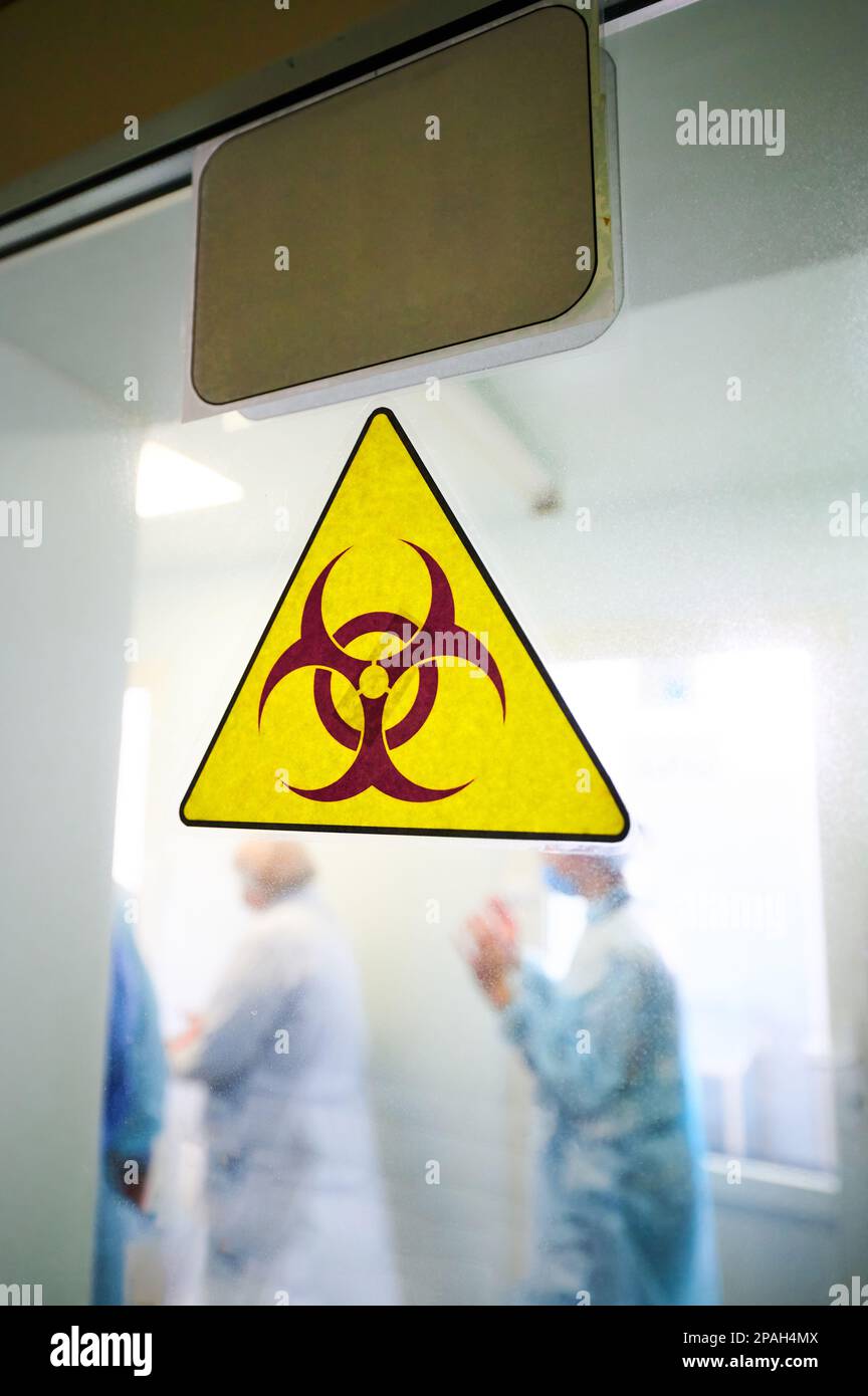 Biohazard warning sign on transparent laboratory door Stock Photo - Alamy