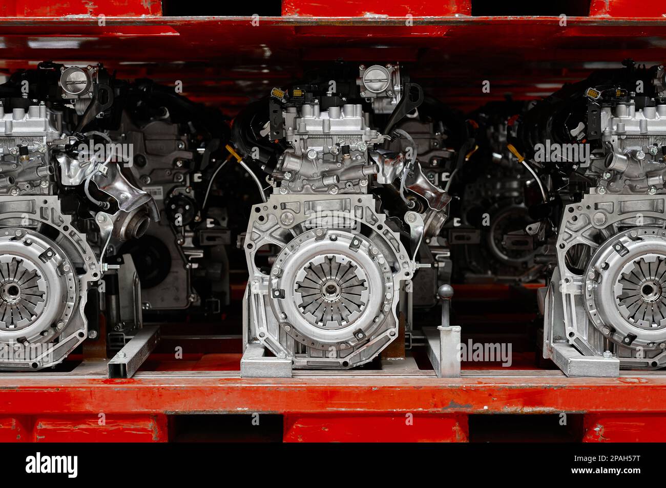 Car internal combustion engines stand on racks in warehouse Stock Photo ...