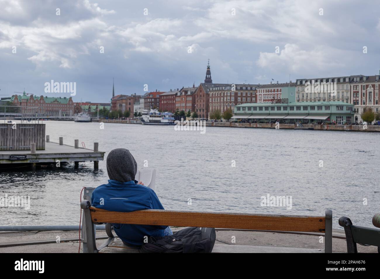 Outdoor scenery and selective focus at man sit and reading book on ...