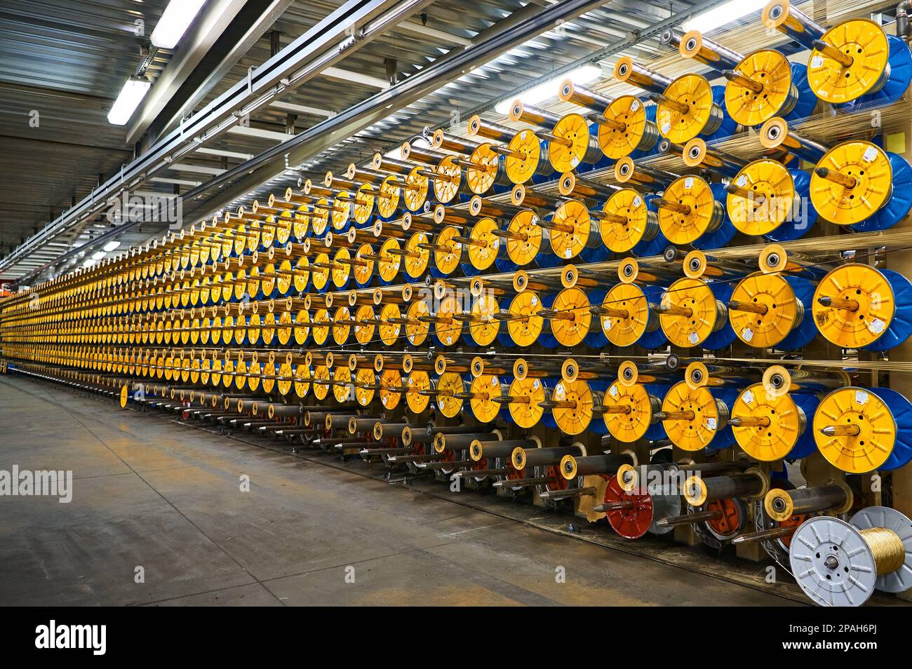 Bobbins coil thin wire to reinforce tires in plant workshop Stock Photo ...