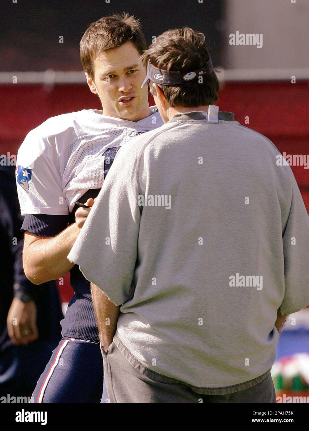 New England Patriots quarterback Tom Brady, left, talks with head coach ...