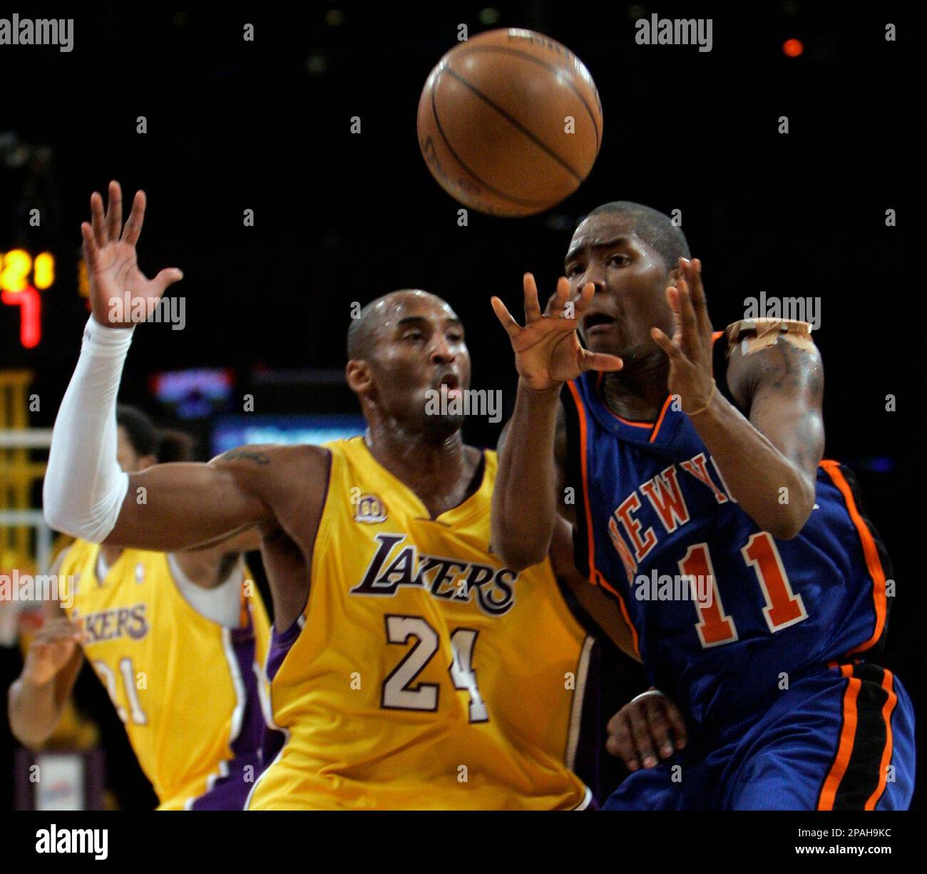 New York Knicks' Jamal Crawford, right, passes under pressure from Los Angeles Lakers' Kobe ...