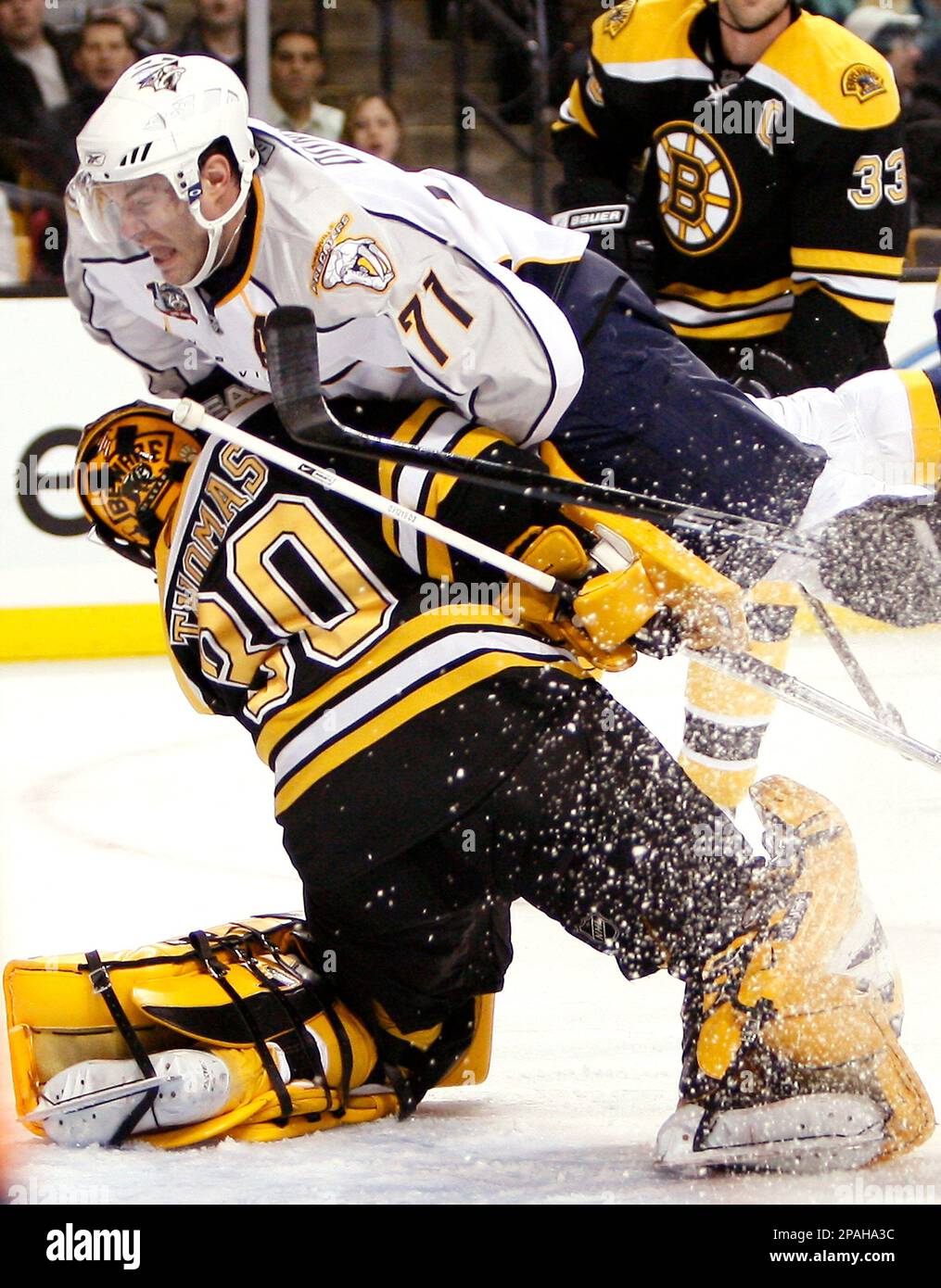 Nashville Predators' J.P.Dumont (71) runs into Boston Bruins goaltender ...