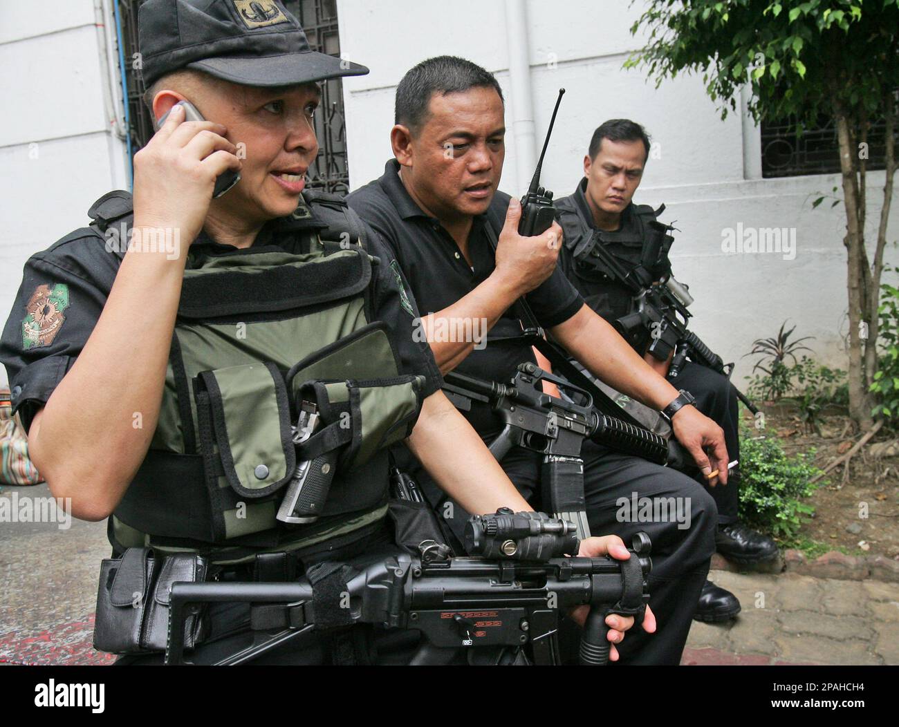Philippine National Police SWAT members gather on the grounds of the ...