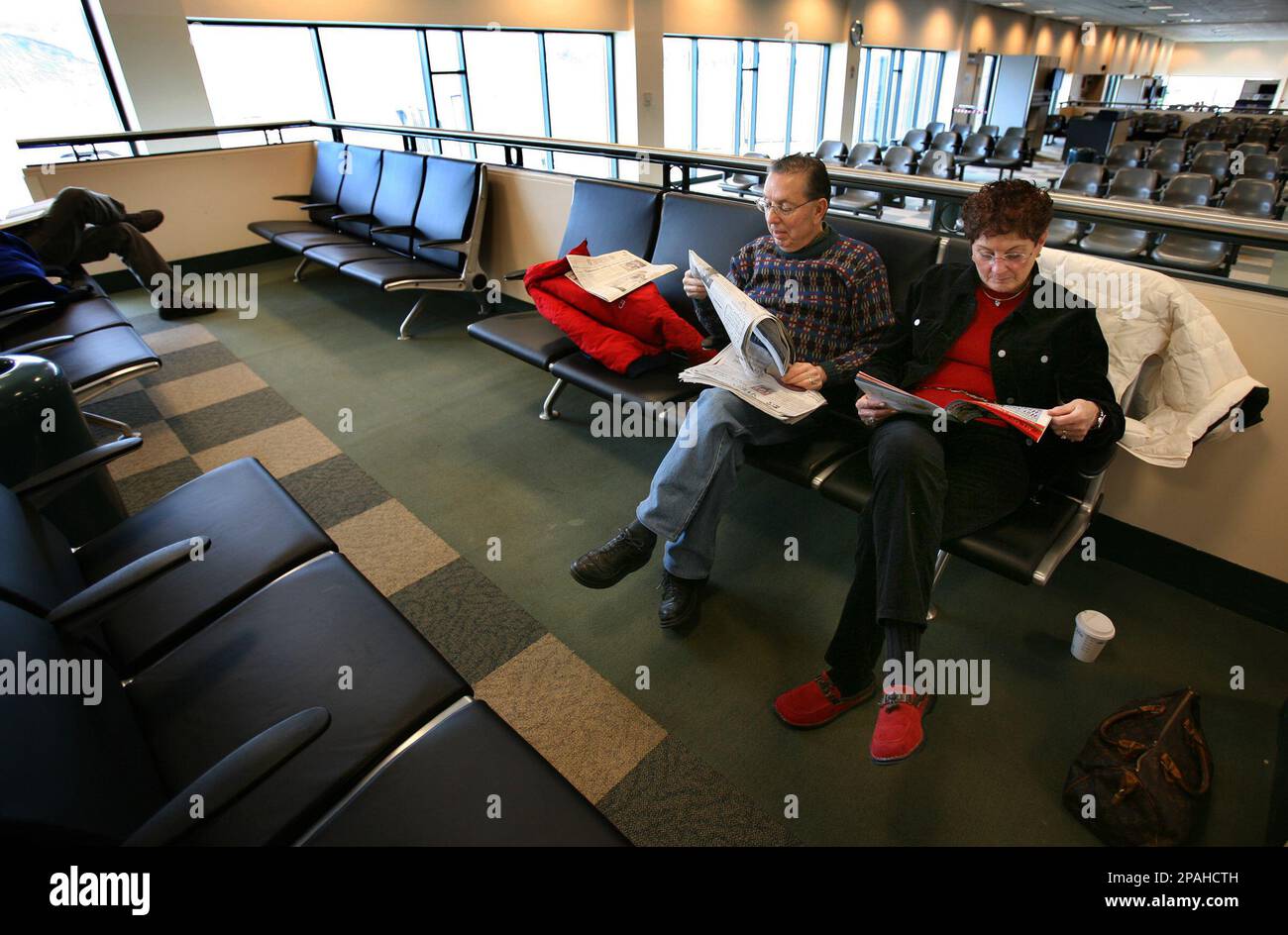 Joe, left, and wife Ann Louise Rizzuto of Delmar, N.Y. read while ...