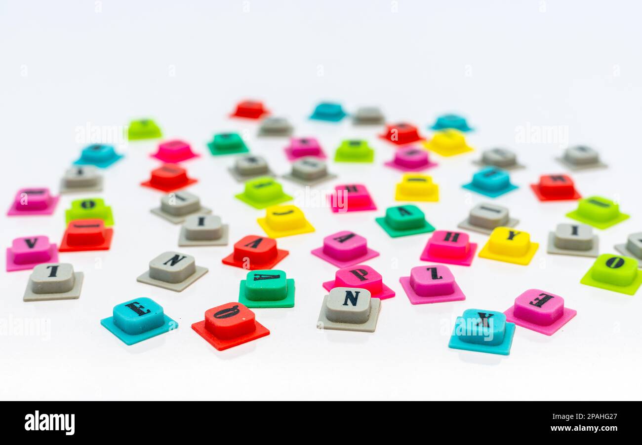 Alphabet letters scattered randomly on white background with selective ...