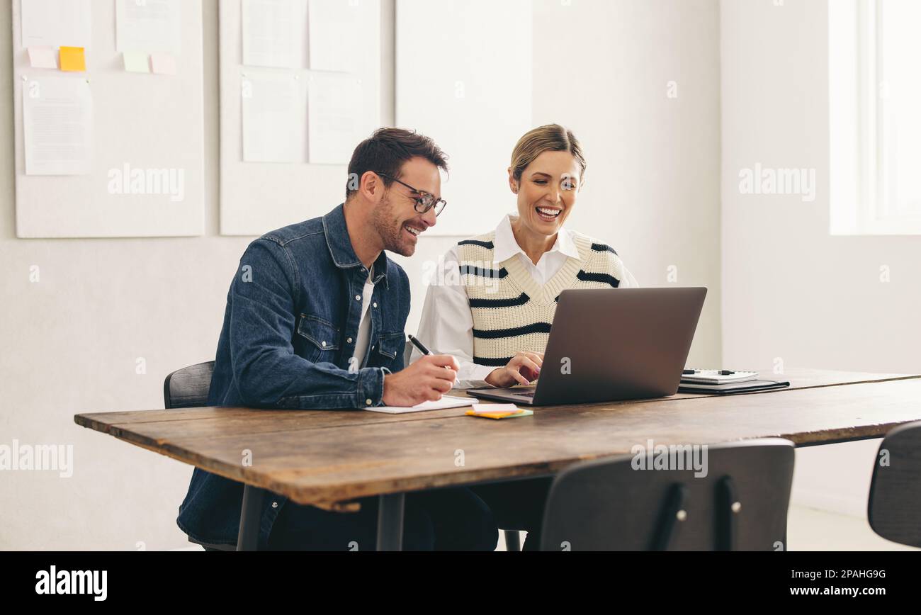 Happy businesspeople smiling cheerfully during an online meeting with ...