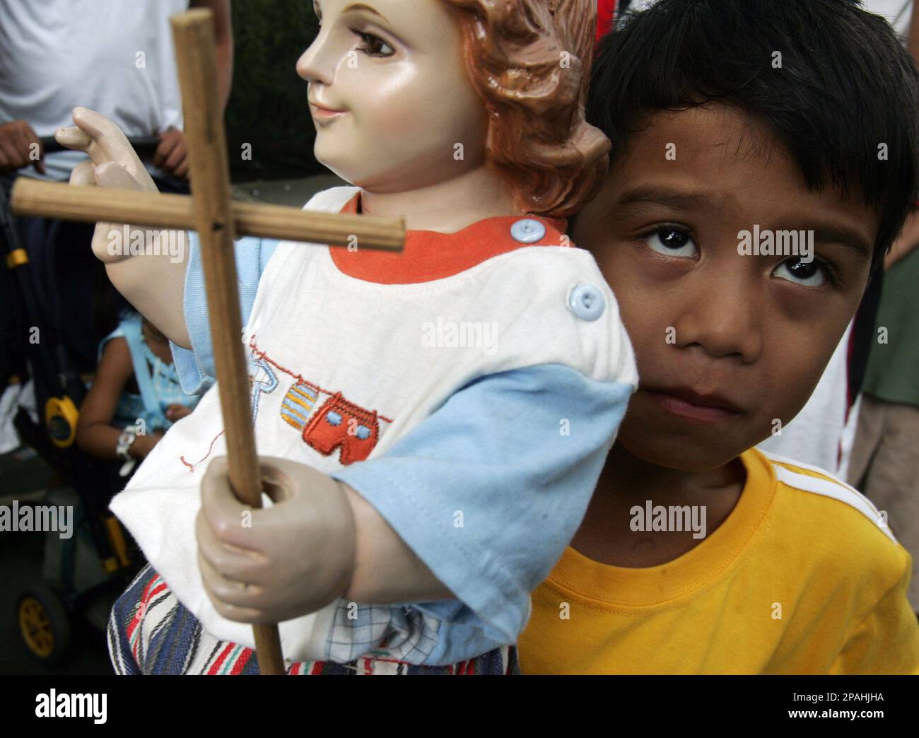 A boy carries his own image of the Child Jesus Christ known as Santo ...