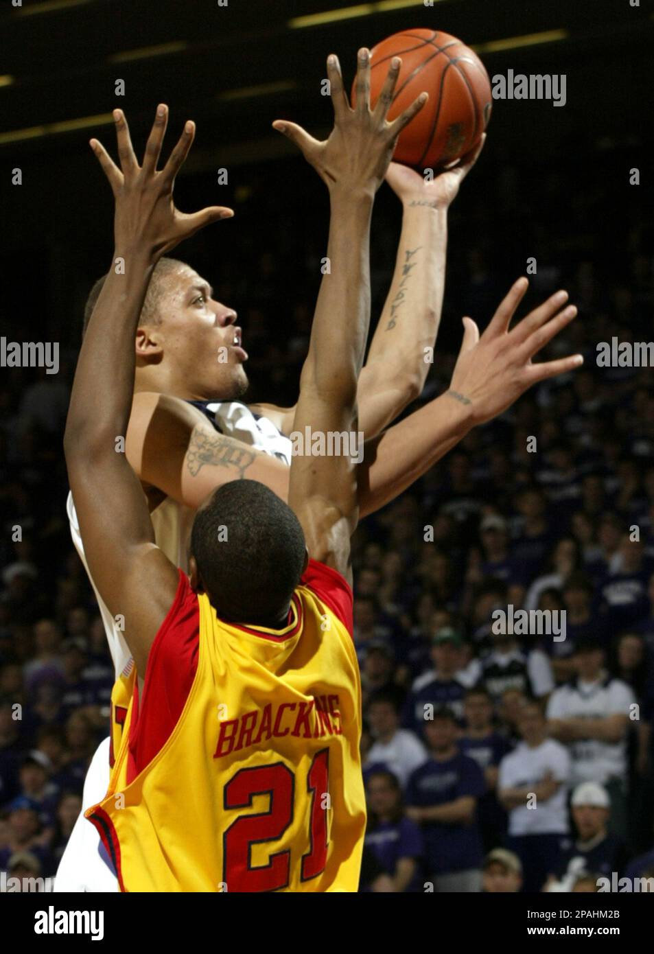 Kansas State's Michael Beasley, back, takes a shot against Iowa State's ...
