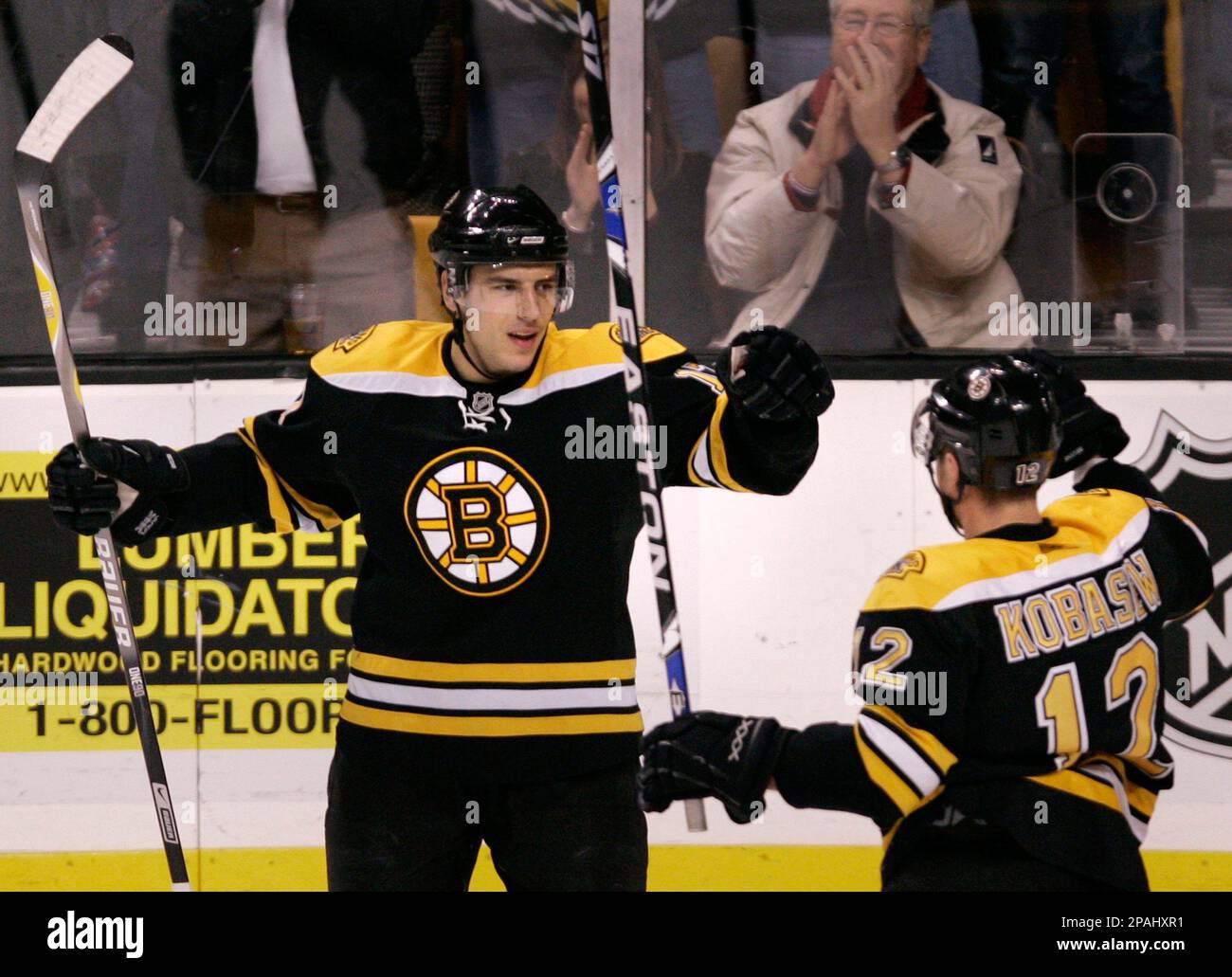 Boston Bruins left wing Milan Lucic, left, is congratulated by teammate ...