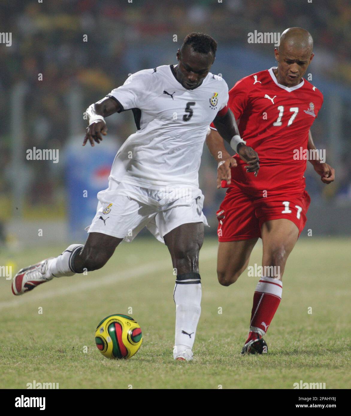 Ghana's John Mensah challenges for the ball with Namibia's Quinton ...