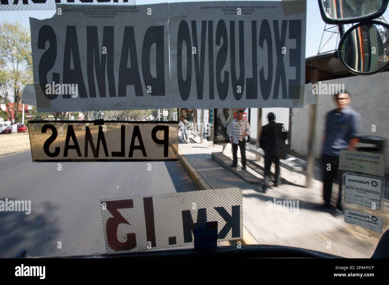 A sign reading in Spanish "Ladies only" covers the windshield of a ...