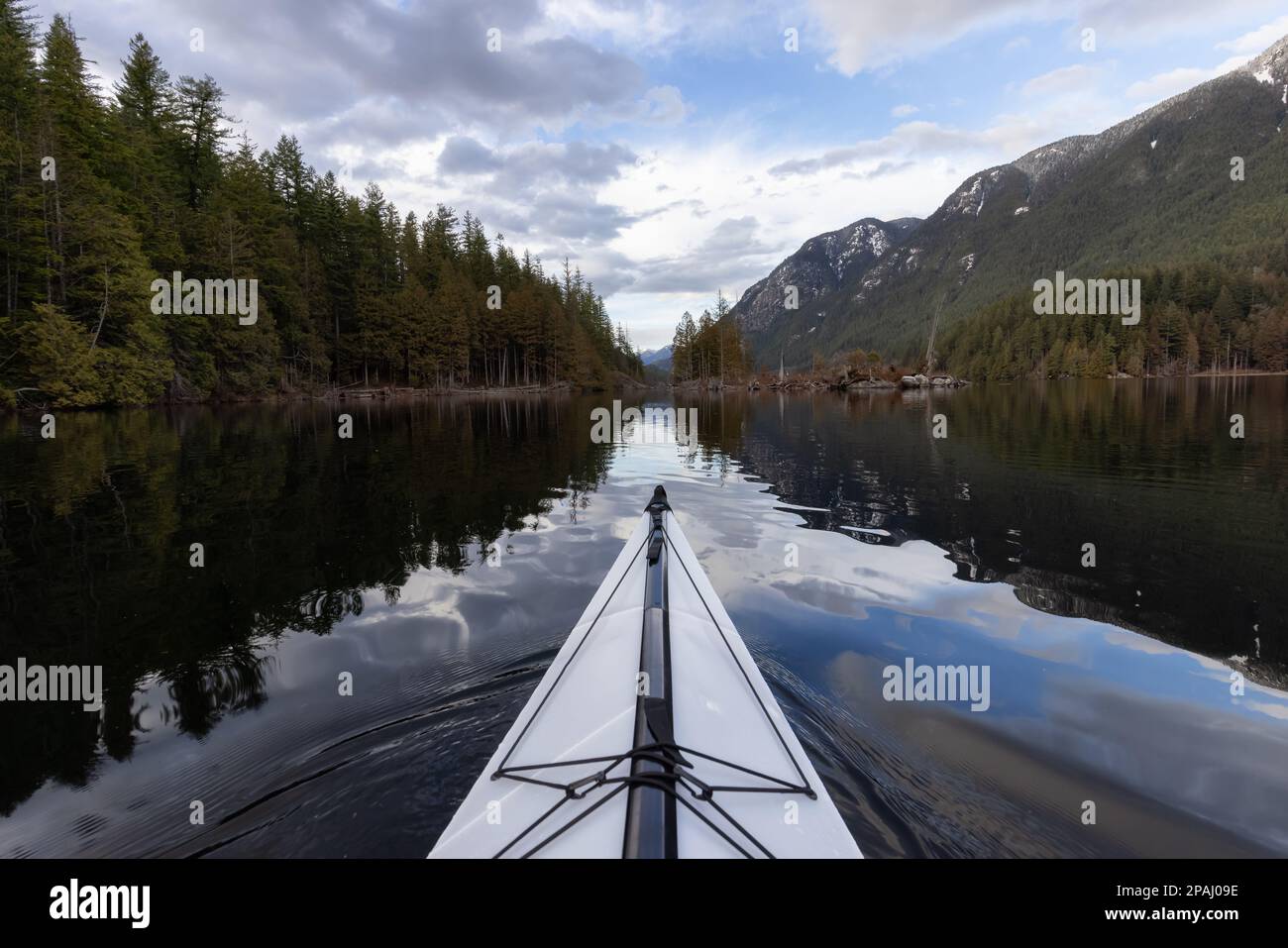 Kayaking in calm water with Canadian Mountain Landscape Background ...