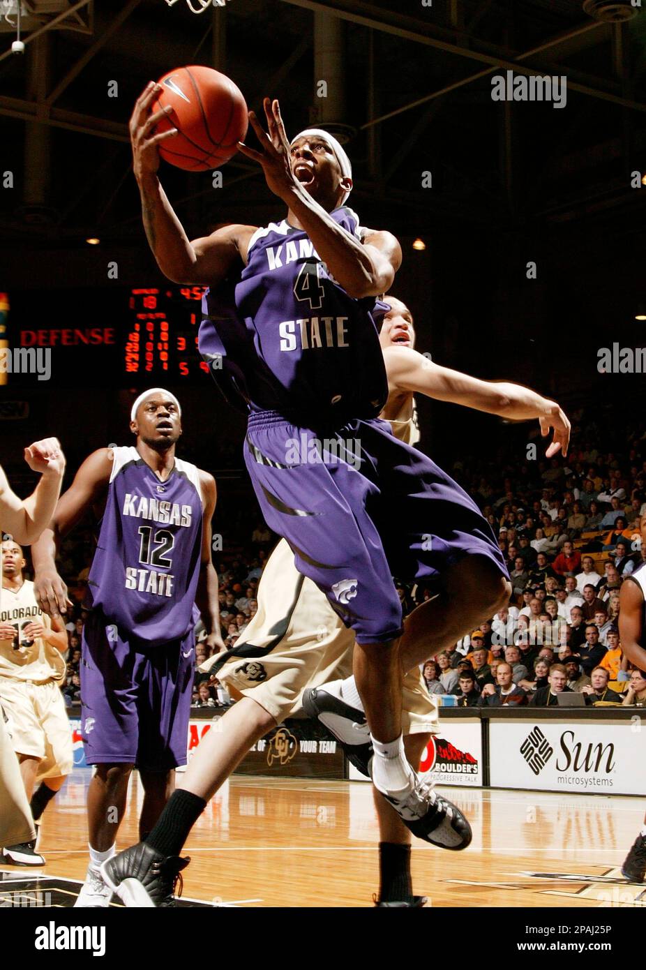 Kansas State forward Andre Gilbert (4) goes up for a shot next to ...