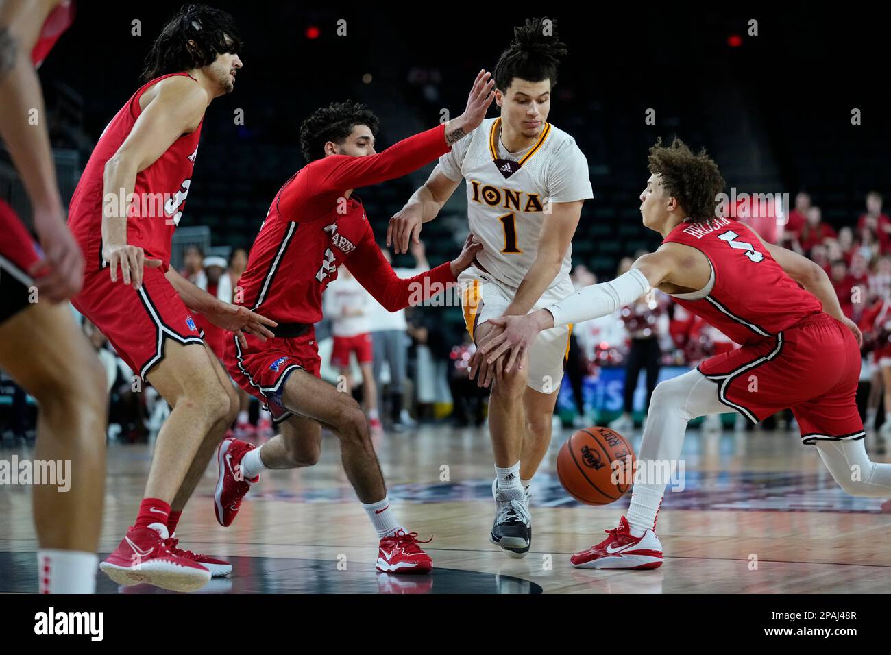 Iona's Walter Clayton Jr. (1) drives against Marist's Patrick Gardner ...