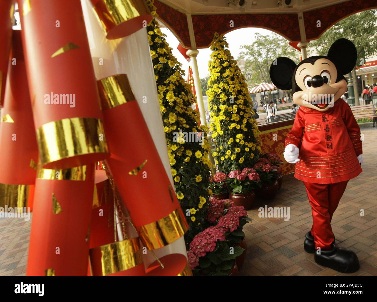 Mickey Mouse displays his Chinese New Year costumes designed by Hong ...