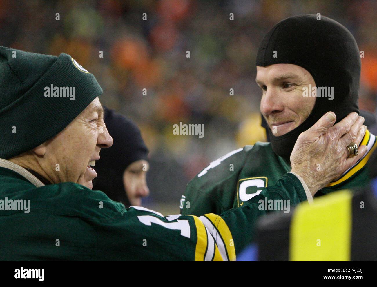 Green Bay Packers quarterback Brett Favre, right, talks with former Packers quarterback Bart ...
