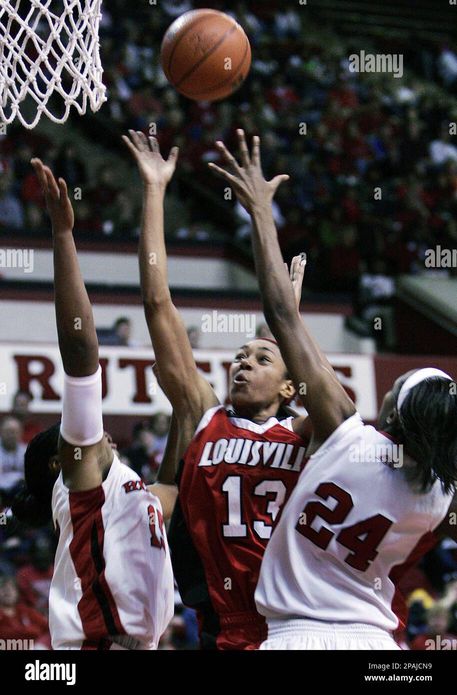 Louisville's Candyce Bingham (13) takes a shot as she splits Rutgers ...