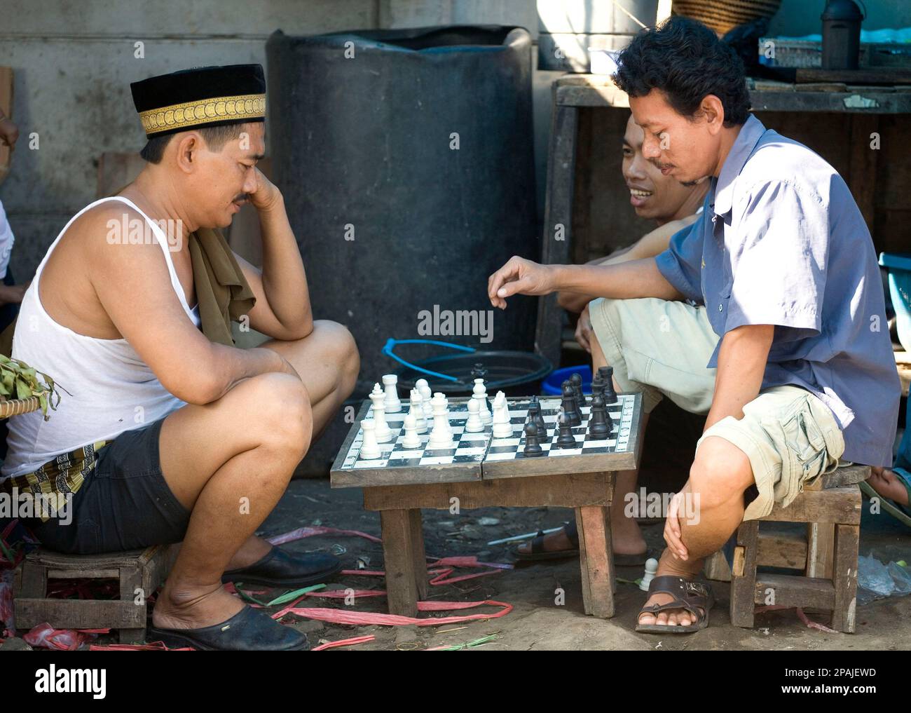 Indonesian men play chess in downtown Jakarta, Sunday, Jan. 20, 2008 ...