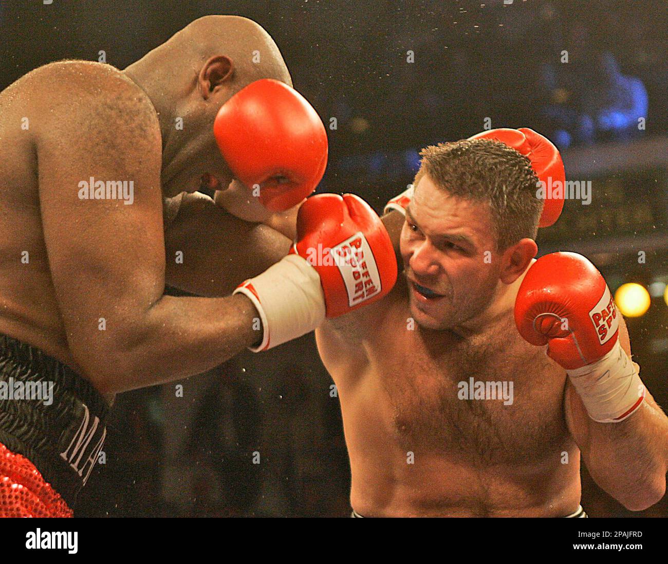 Defending champion Uzbekistan's Ruslan Chagaev, right, punches at ...
