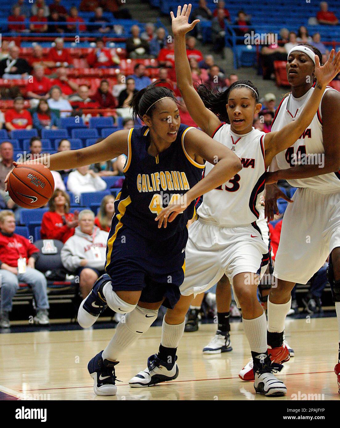 California's Ashley Walker (44) drives past the attempted defense of ...