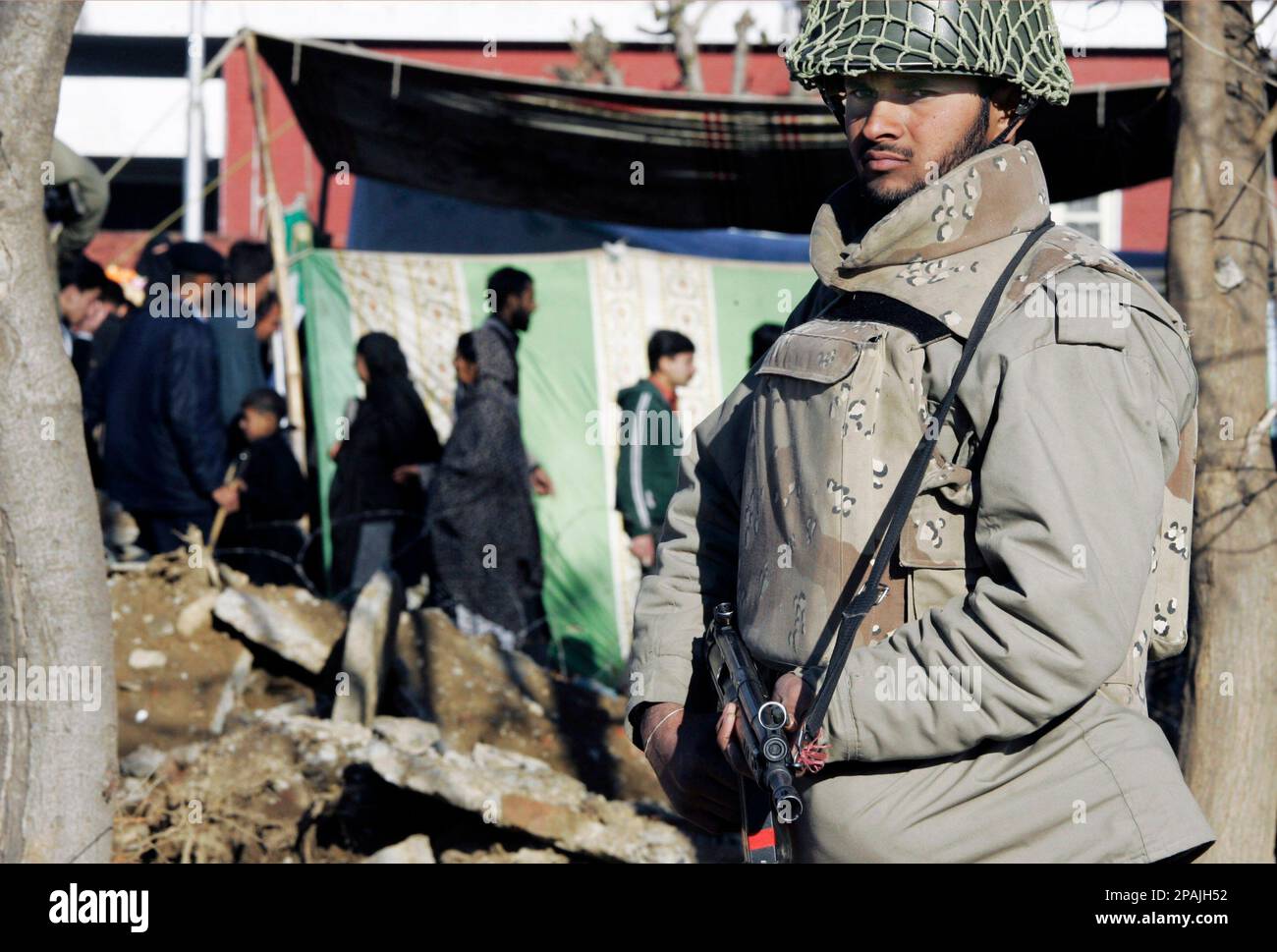 A Pakistani soldier guards Shia Muslims during a Muharram procession ...