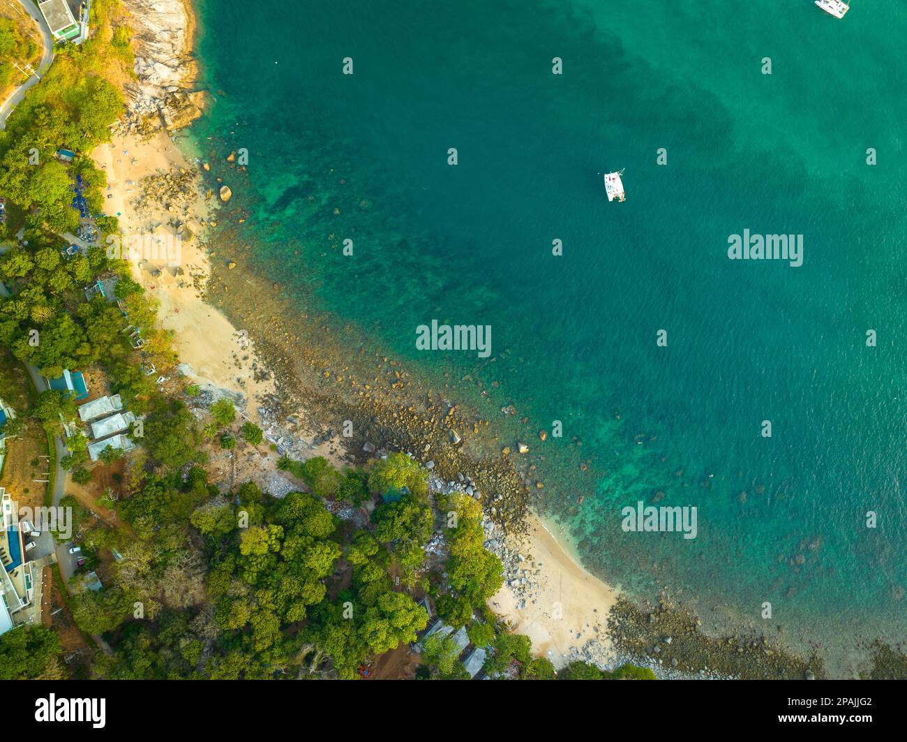 aerial top view Ao Sean small white sand beach lined with rocks. turquoise sea at Ao Sane beach ...