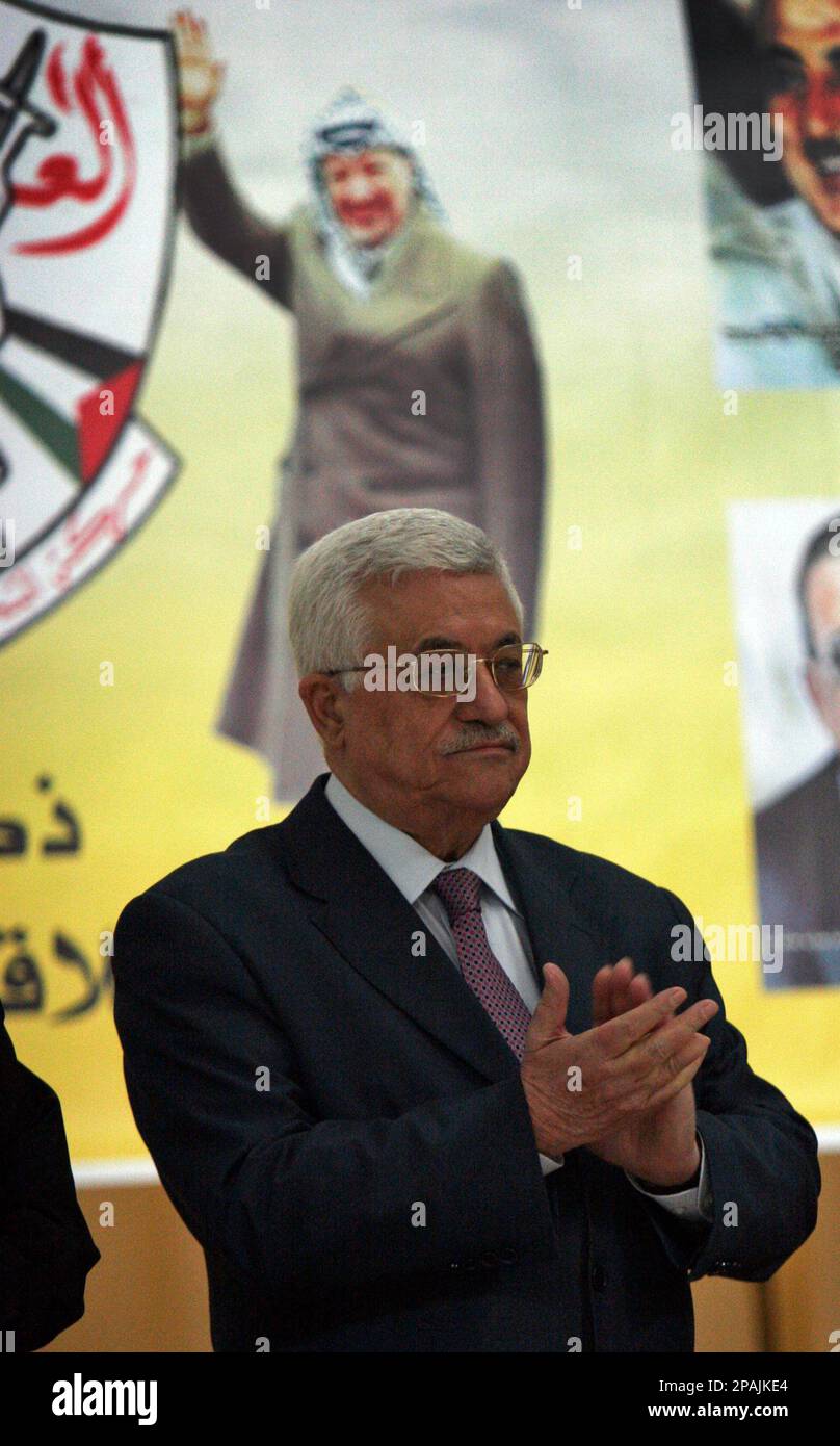Backdropped by a picture of late Palestinian leader Yasser Arafat ...