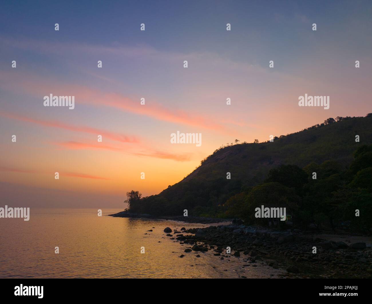 aerial view the sun going down in colorful sky impact on ocean surface ...
