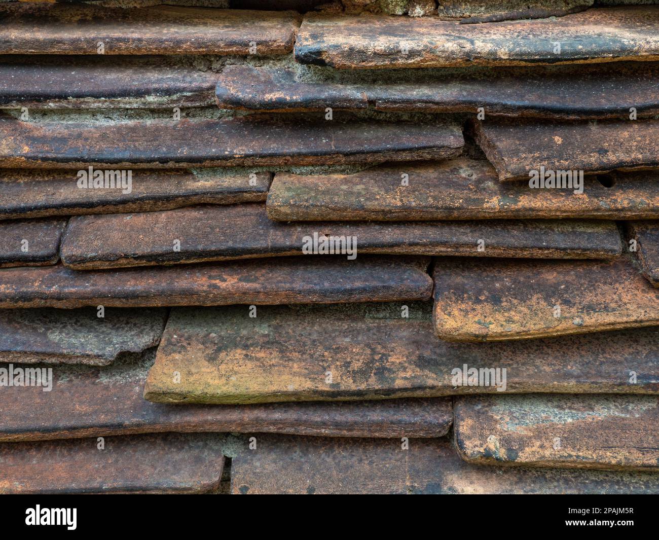 Background from the old tiled masonry. Orange tiles. Wall made of clay ...