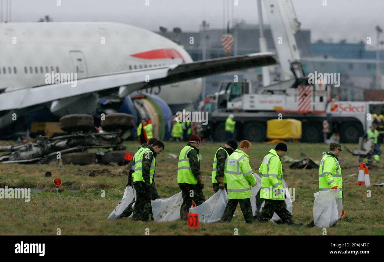 Accident investigators look through the wreckage, Friday Jan. 18, 2008 ...