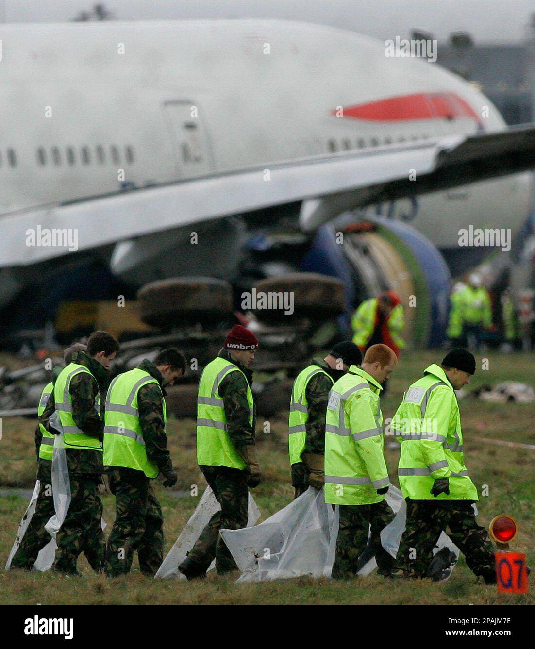 Accident investigators look through the wreckage, Friday Jan. 18, 2008 ...