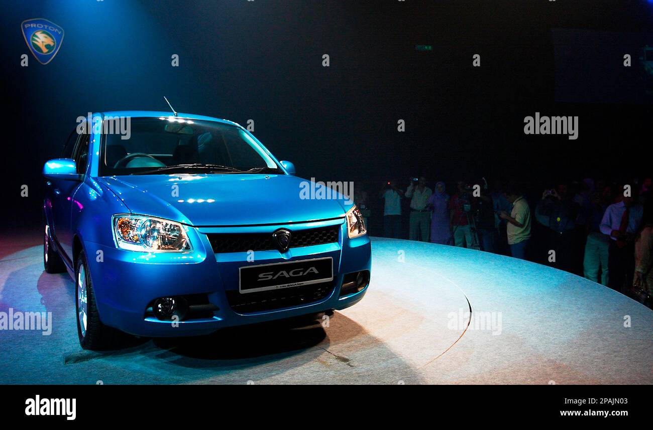 Visitors look at Proton's new model "Saga" on display in Kuala Lumpur ...