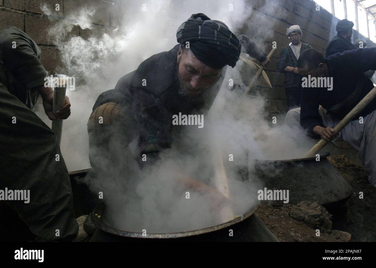 Shias prepare food in a community kitchen which will be distributed ...