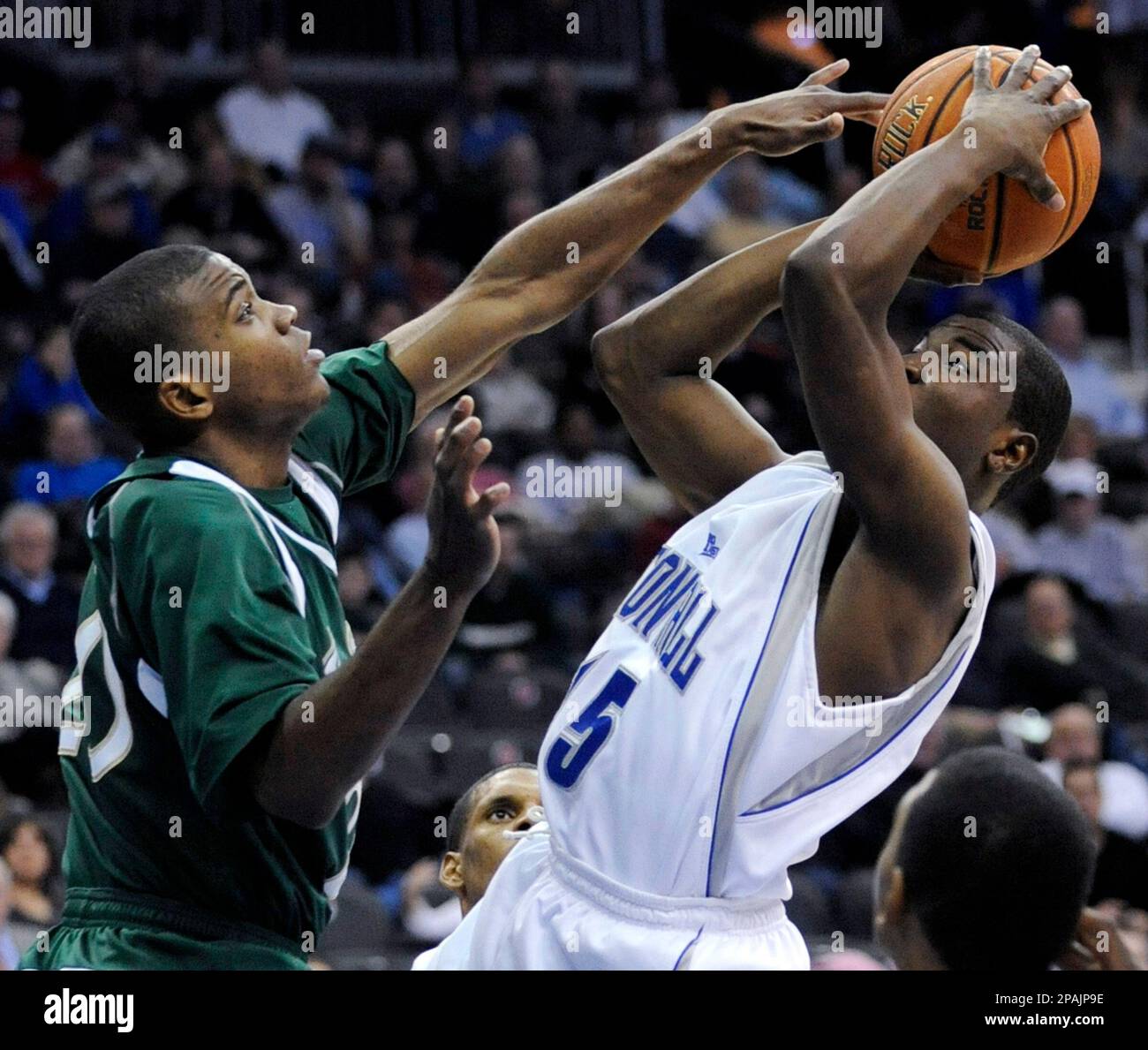 South Florida's Aaron Holmes, left, blocks a shot by Seton Hall's ...