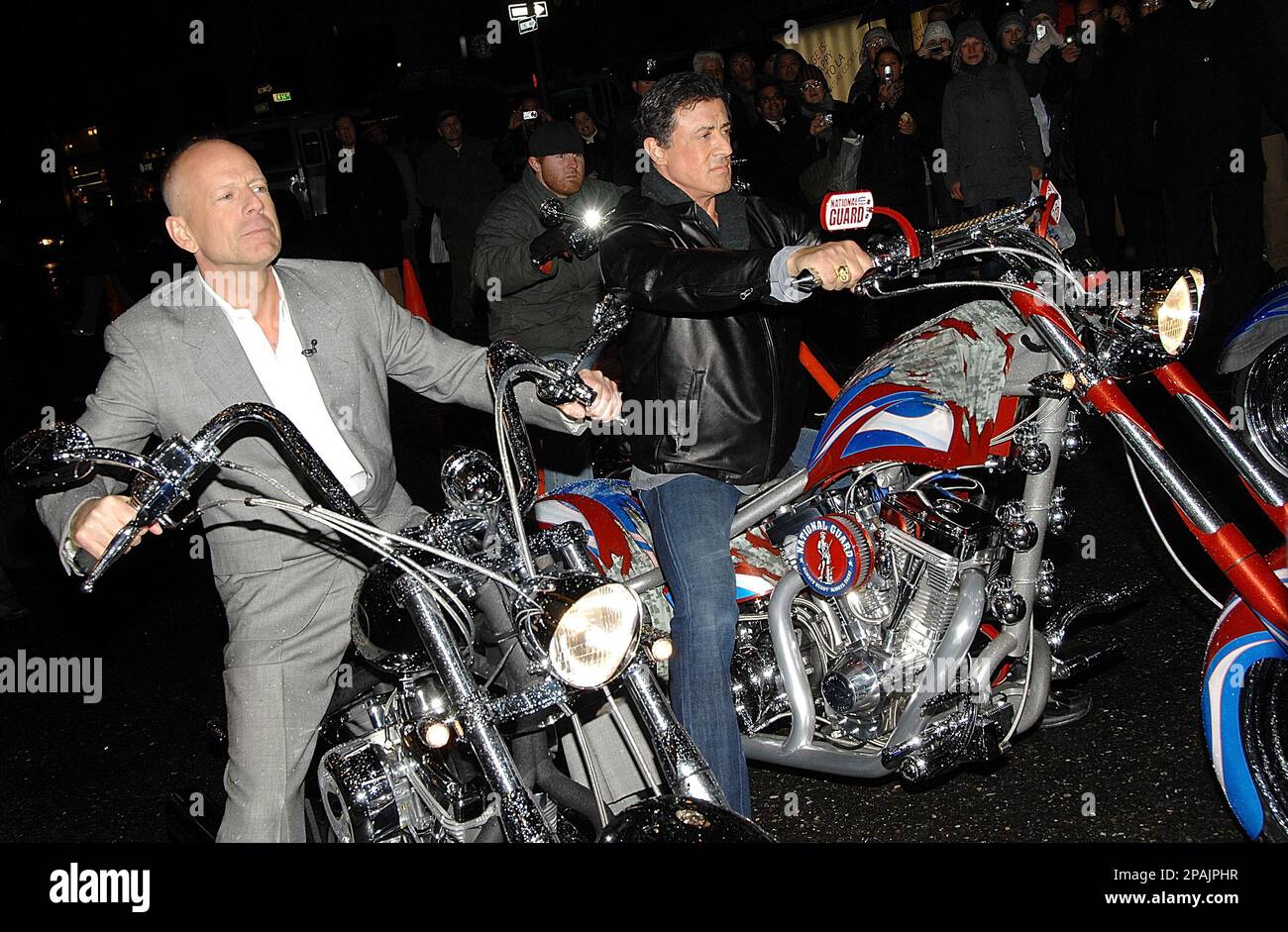 Actors Bruce Willis, left, and Sylvester Stallone ride motorcycles ...