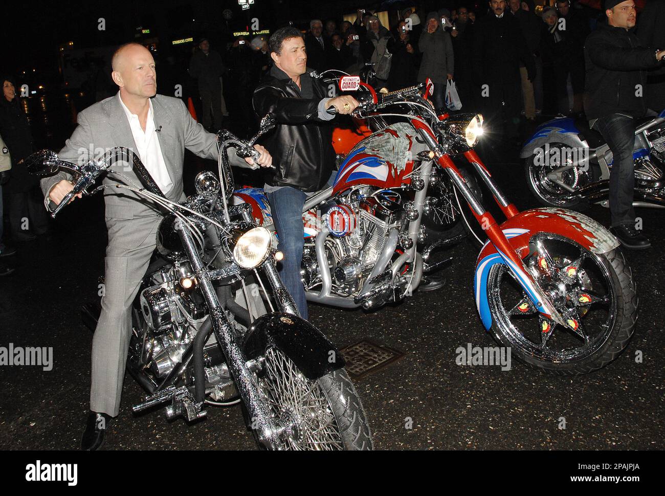 Actors Bruce Willis, left, and Sylvester Stallone ride motorcycles ...