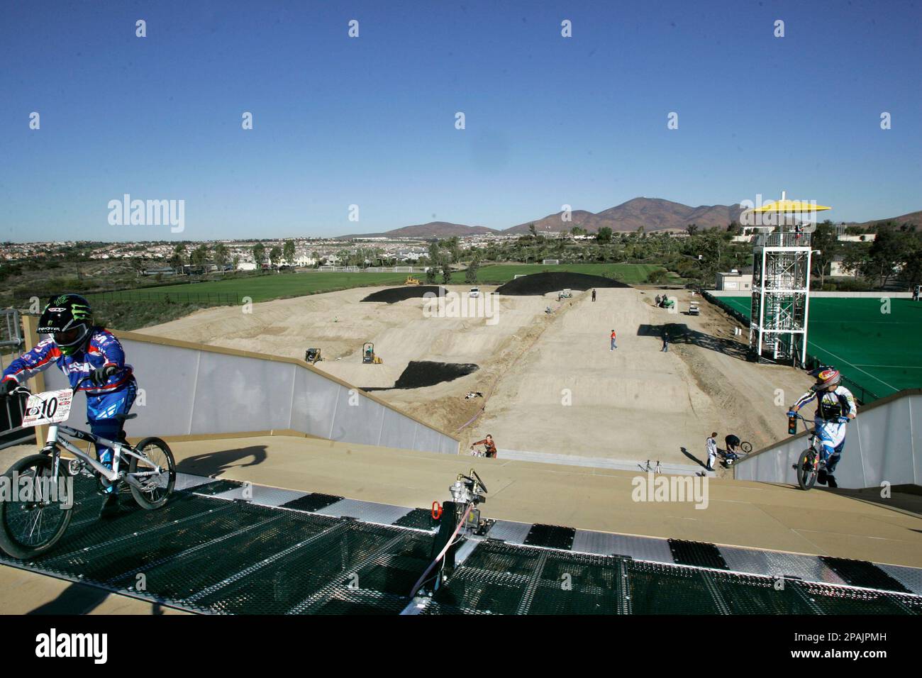 BMX riders push their bikes up the ramp as they test the new BMX ...