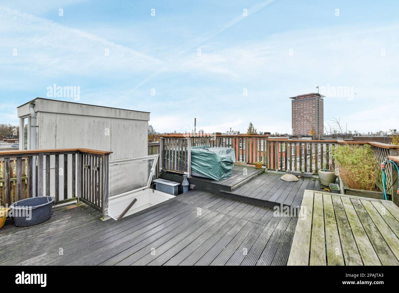 a rooftop area with wooden decking and lots of trash on the ground in ...