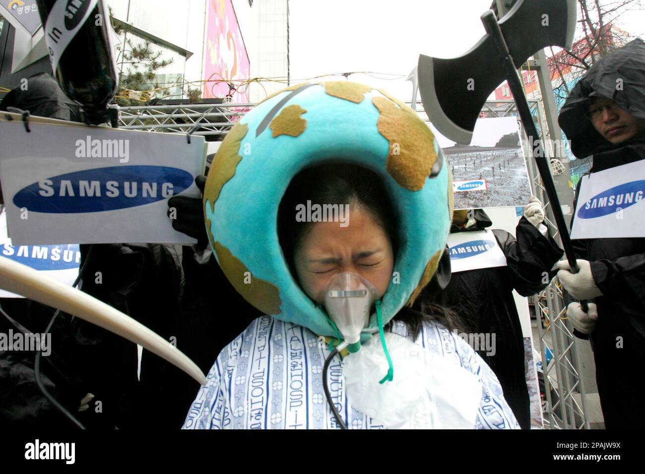 A South Korean environmental activist, wearing an oxygen mask in a ...
