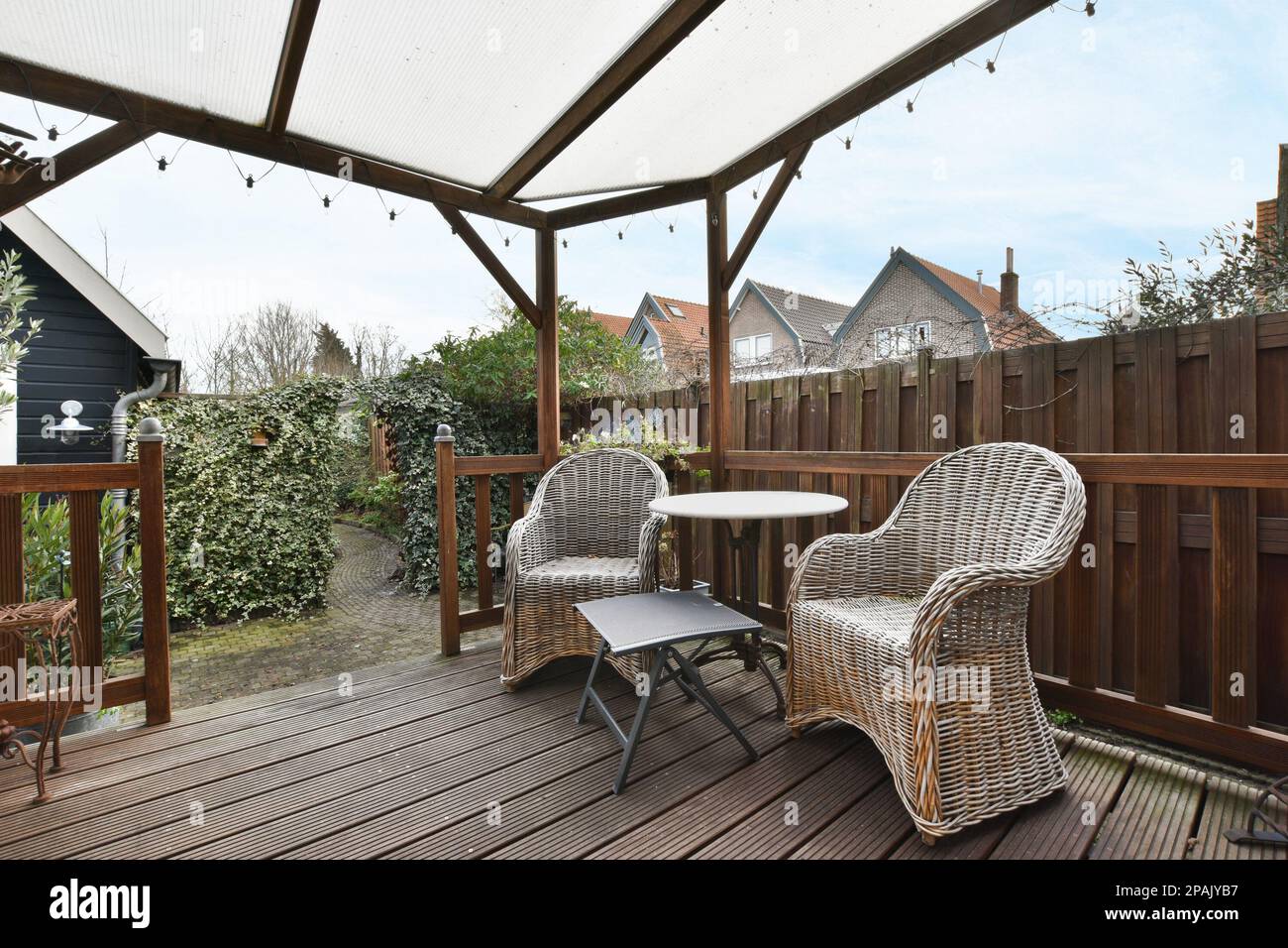 an outside area with chairs and tables under a white awning on a wooden ...